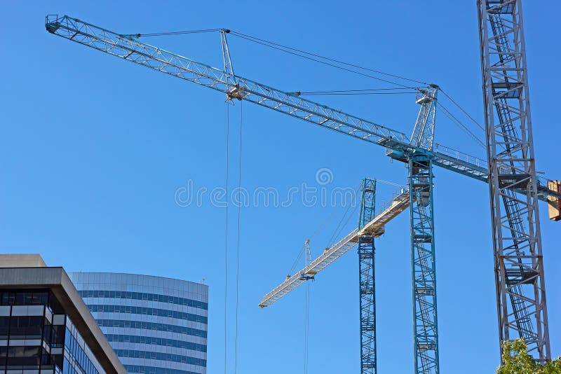 Multiple Construction Cranes Work Side by Side. Stock Image - Image of ...