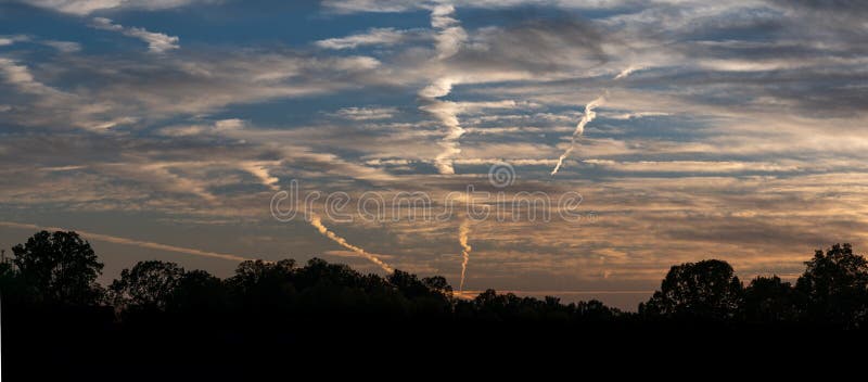 Multiple Contrails Stretching Across the Beautiful Sunset Sky Stock ...