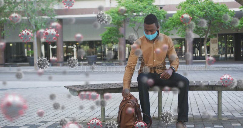 Multiple Covid-19 Cells Floating Against Man Wearing Face Mask Checking ...