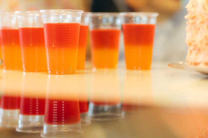 Multiple Cups of Red and Orange Jello Next To Each Other on a Counter ...