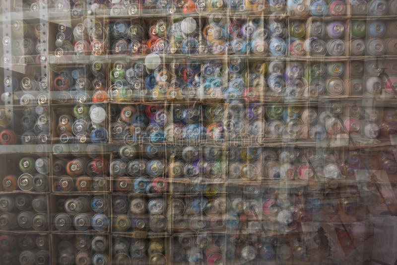 Multiple Exposure Photo of Spraycans on a Shelf, Background Pattern ...