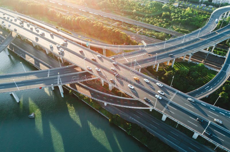 Aerial View of Multiple Highways Intersect Above a Calm River ...
