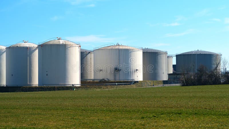 Multiple Large Storage Silos Standing in an Open Field Under a Clear ...