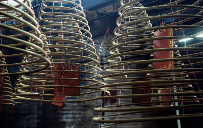 Multiple Large Yellow Incense Coils Hanging in Stacks from the Ceiling ...
