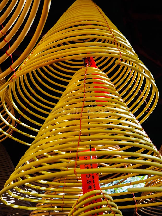 Multiple Large Yellow Incense Coils Hanging in Stacks from the Ceiling ...