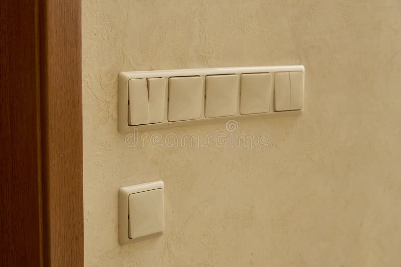 Multiple Light Switches on Wall with Wooden Frame Stock Image - Image ...