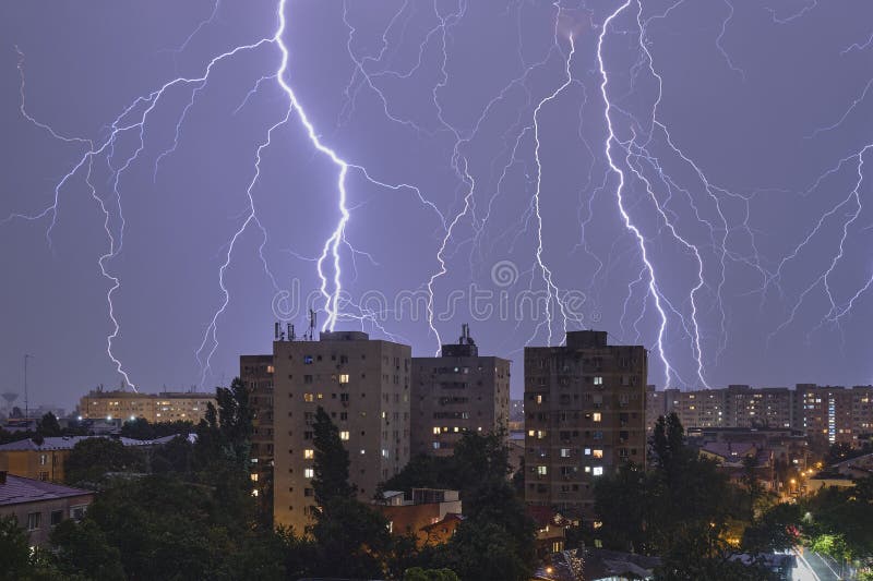 Multiple Lightning Strikes and Thunderstorm Over City Buildings, at ...