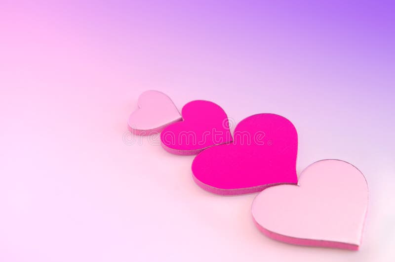 Multiple Pink Hearts Shaped Pieces Align with Light Pink Background ...