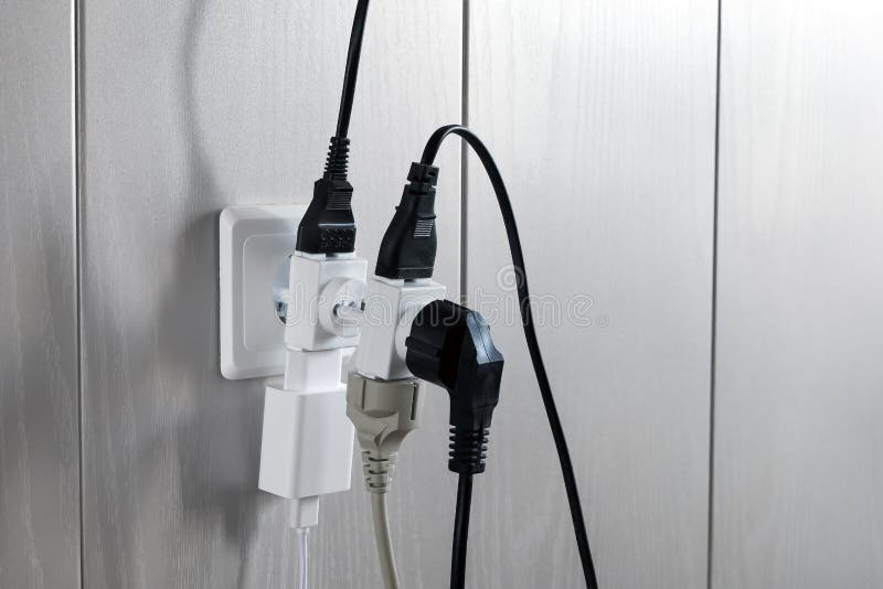 Multiple Plugs in Wall Electrical Outlet is Dangerous Overload, Close ...