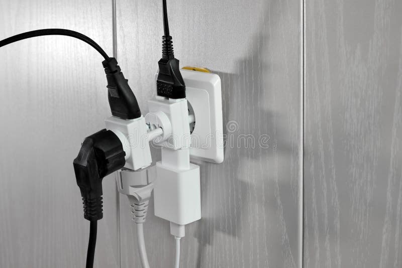 Multiple Plugs in Wall Electrical Outlet is Dangerous Overload, Close ...