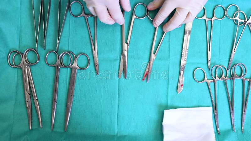 Multiple Surgery Instruments on Blue Table Above View. Surgeon Take ...