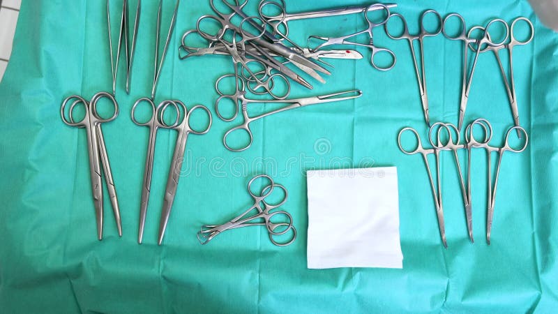 Multiple Surgery Instruments on Blue Table Above View. Surgeon Take ...