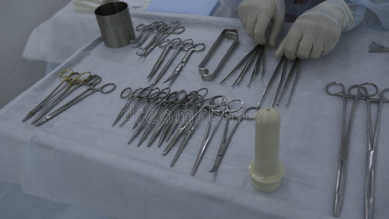 Multiple Surgery Instruments on Blue Table. Action. Surgeon Put Down ...