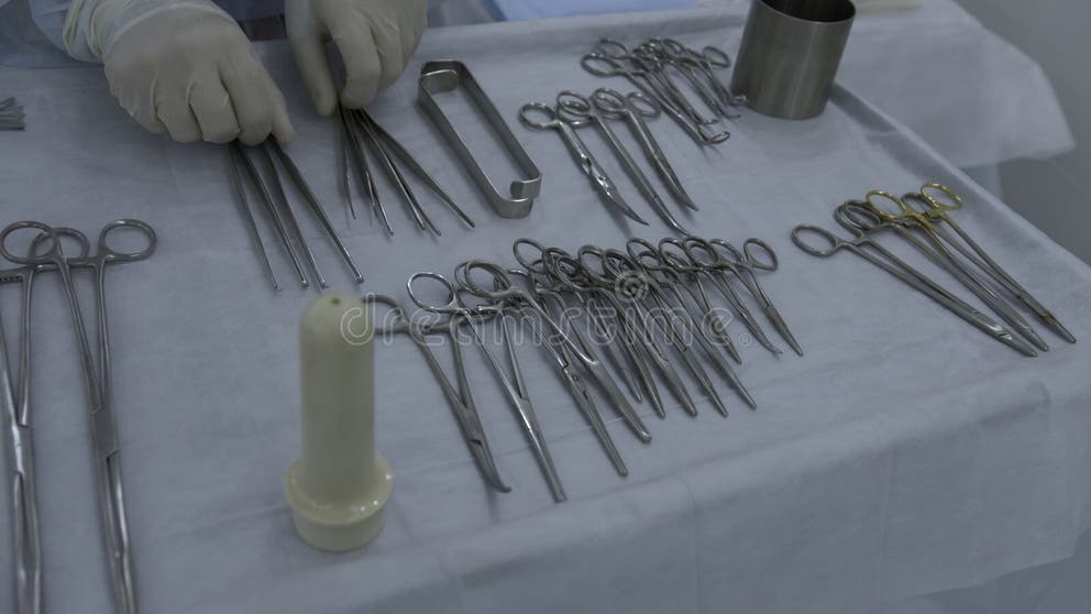 Multiple Surgery Instruments on Blue Table. Action. Surgeon Put Down ...