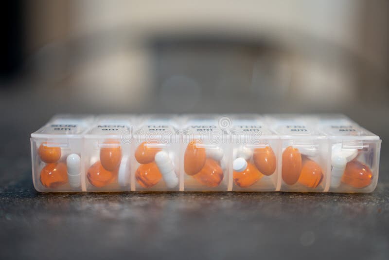 Multiple Types of Pills in a daily Container on Counter Top Stock Image ...