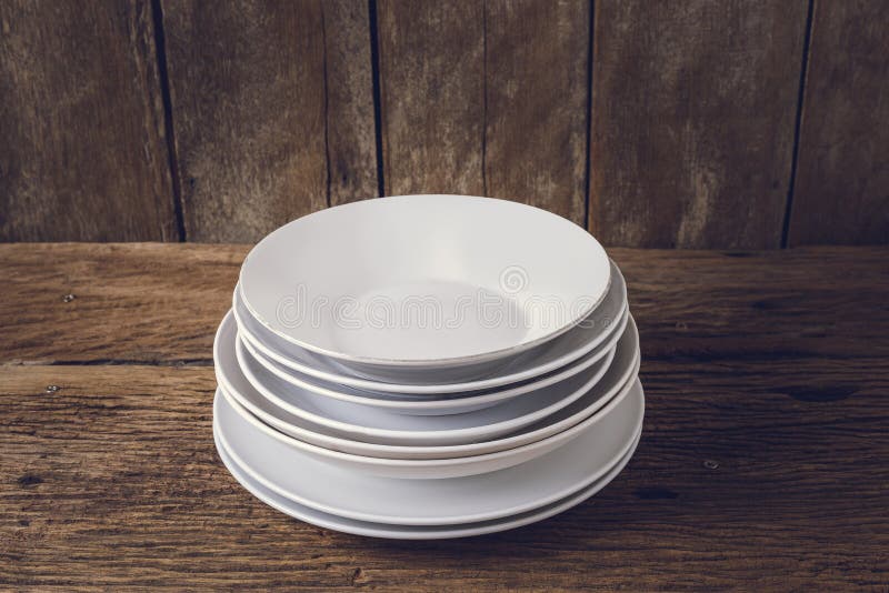 Multiple White Dish Plate on Grunge Wooden Table Stock Image - Image of ...