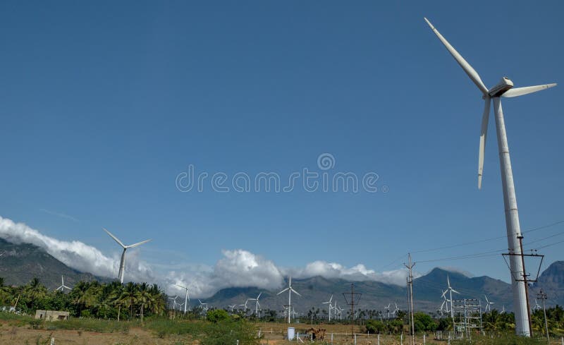 Multiple Wind Turbines Standing on a Hill at Sunset and Generating ...