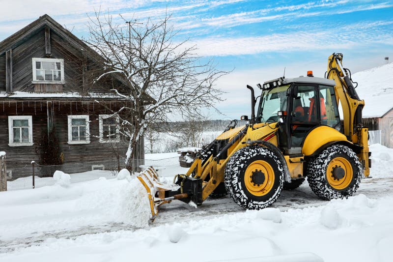 Backhoe Loader with Hydraulic Front-mounted Snow Blade Clears Compacted ...