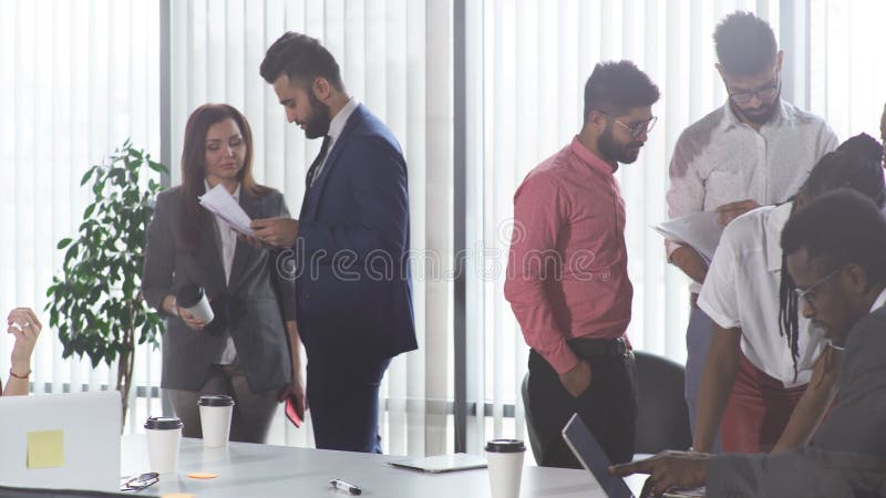 Diverse Smiling Businesspeople Having Conversation Standing Together at ...