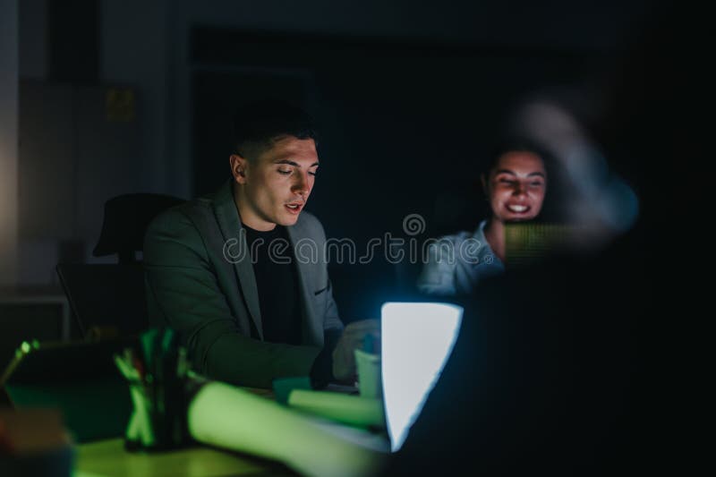 Multiracial Business Team Working Intensely at Night, Focusing on ...