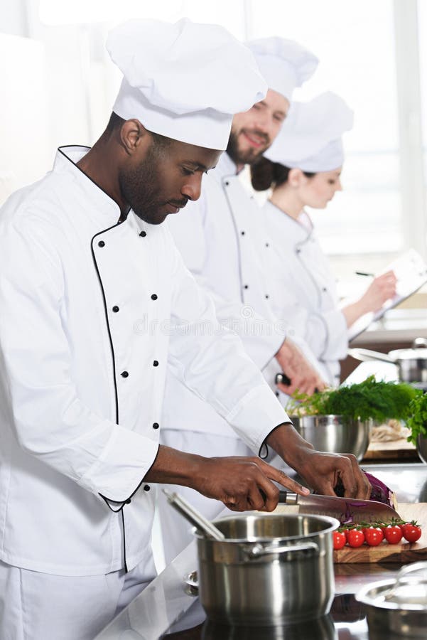 Multiracial Chefs Team Discussing Recipe and Cooking Stock Photo ...