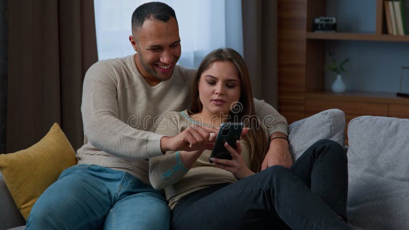 Multiracial Happy Carefree Couple Indian Man Hispanic Woman Watching