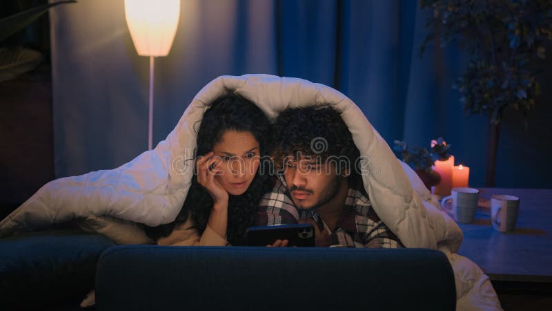 Multiracial Couple Man And Woman Shocked Watching Horror Film Movie