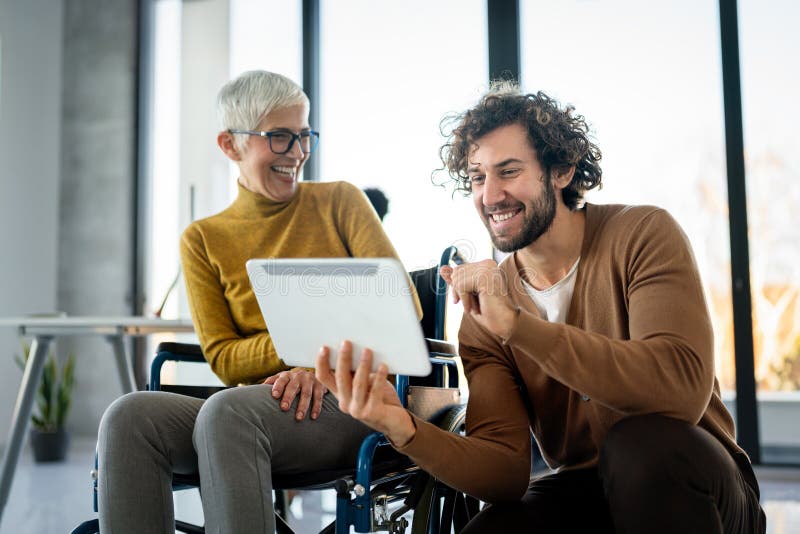 Multiracial Coworkers Analyzing Charts and Working Together Showing ...