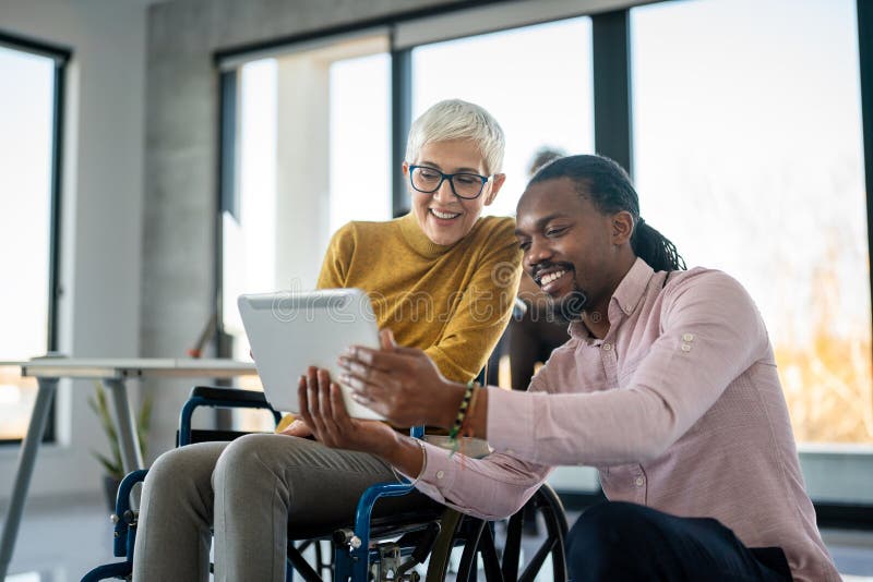 Multiracial Coworkers Analyzing Charts and Working Together Showing ...