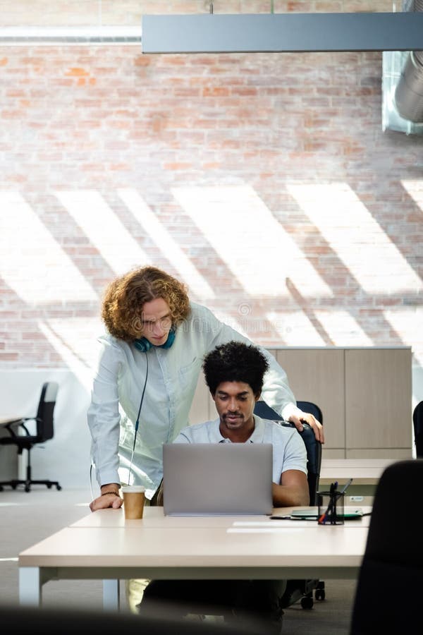 Multiracial Coworkers Look at Computer Together in the Office. Copy ...