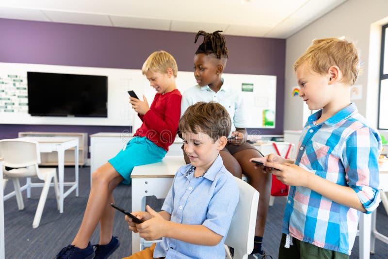 Multiracial Elementary Schoolboys Using Smart Phone in Classroom during ...