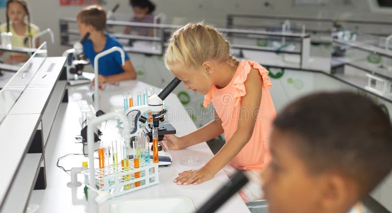 Multiracial Elementary Students Looking through Microscope during ...