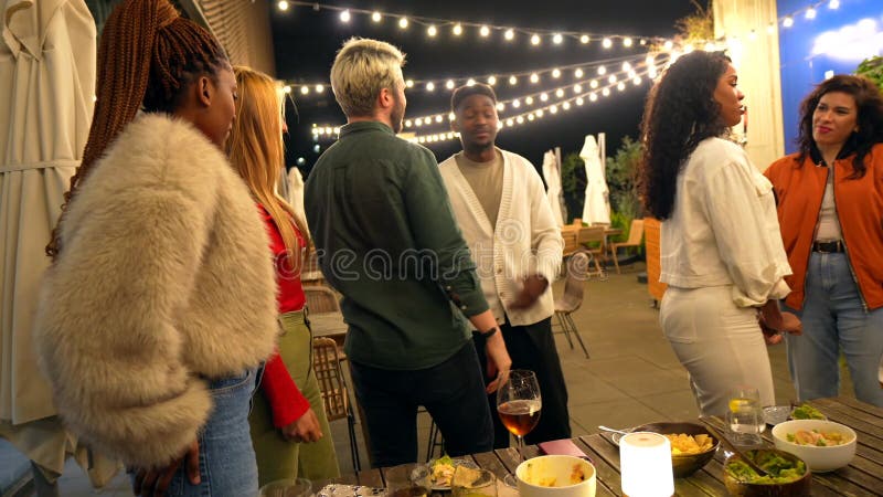 Friends Saying Goodbye on a Terrace at Night Stock Video - Video of ...