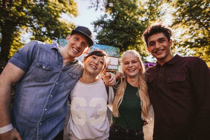 Multiracial Friends Standing Together in Amusement Park Stock Photo ...