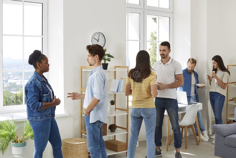 Multiracial Group of Beautiful Young People Split into Pairs To Solve a ...