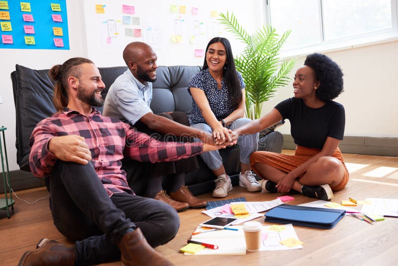 Multiracial Group of Colleagues Put Hands Together in Stack, Celebrate ...