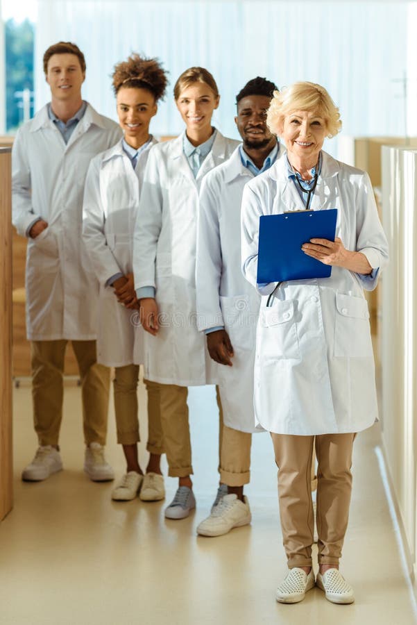 A Multiracial Group of Doctors in Lab Coats Standing in a Row Stock ...