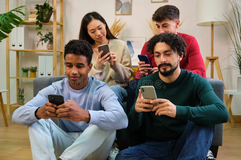 Multiracial Group of Friends Using the Phone at Home. Stock Photo ...