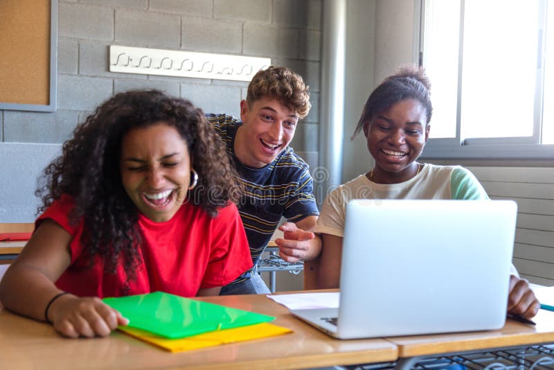 Multiracial Group of High School Students Laughing Together in Class ...