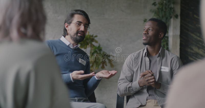 Multiracial Group of Men and Women Talking Sharing Problems Focused on ...