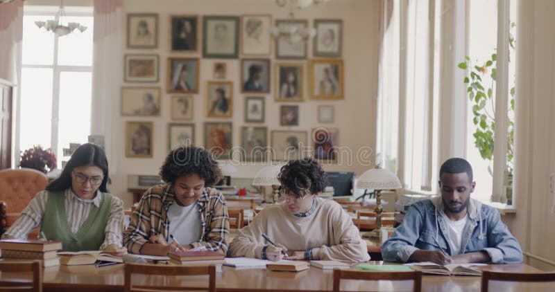 Multiracial Group of Students Studying Together Then Looking at Camera ...