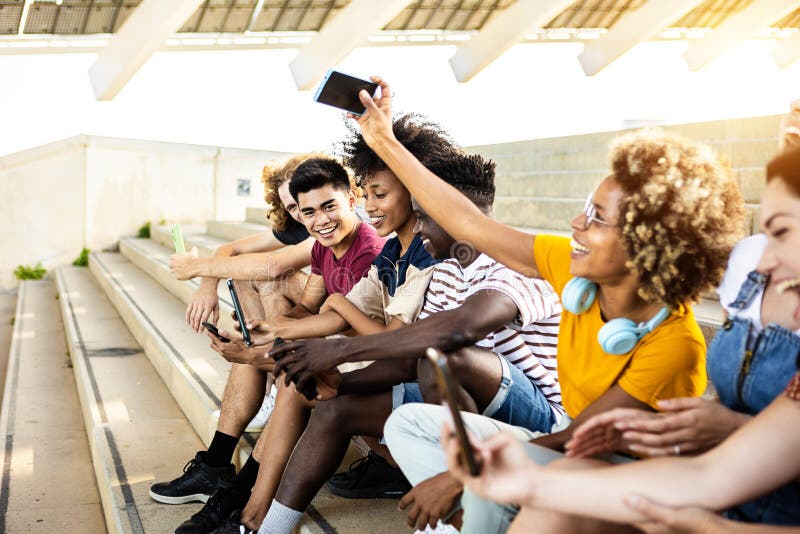 Multiracial Group of Teenager Students Using Mobile Phone Outdoors ...