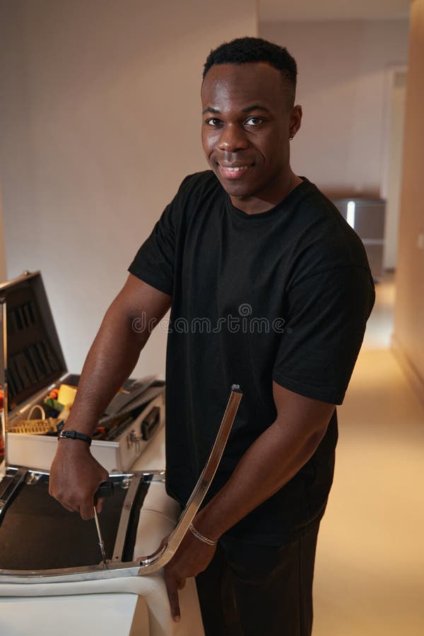 Multiracial Man Fixing Chair with Socket Spanner Stock Image - Image of ...