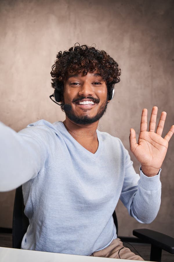 Multiracial Man Influencer Sitting and Gesturing with Expression at ...