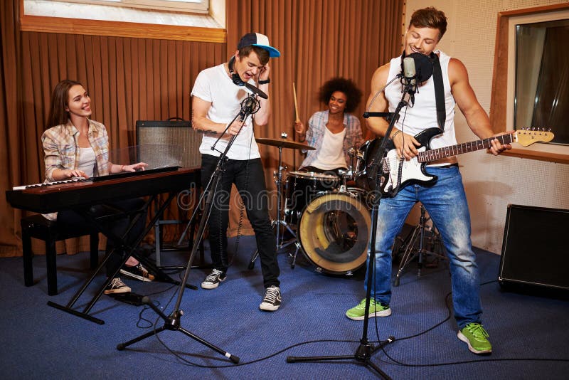 Multiracial Music Band Performing in a Recording Studio Stock Photo ...