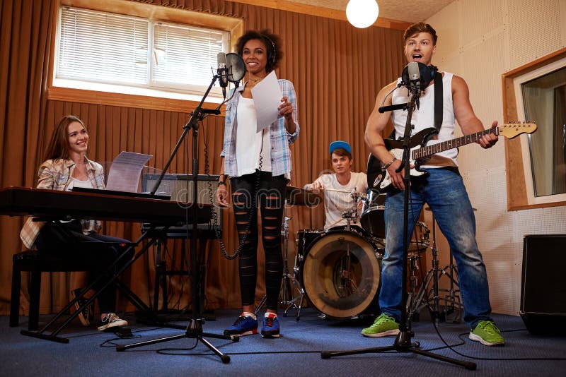 Multiracial Music Band Performing in a Recording Studio Stock Photo ...