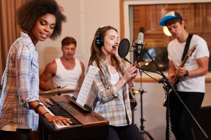 Multiracial Music Band Performing in a Recording Studio Stock Image ...