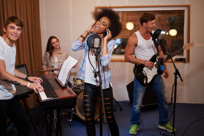 Multiracial Music Band Performing in a Recording Studio Stock Photo ...