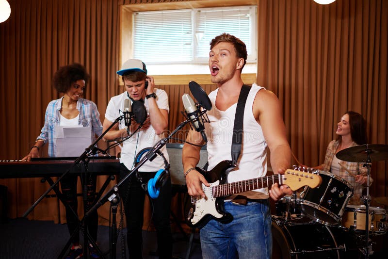 Multiracial Music Band Performing in a Recording Studio Stock Photo ...