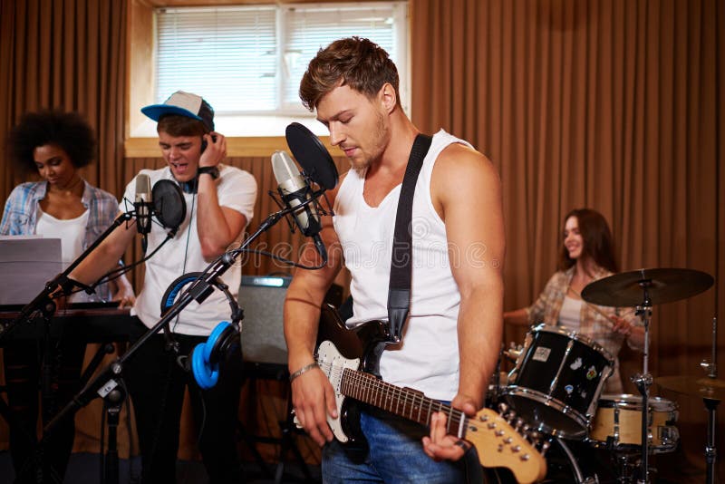 Multiracial Music Band Performing in a Recording Studio Stock Photo ...